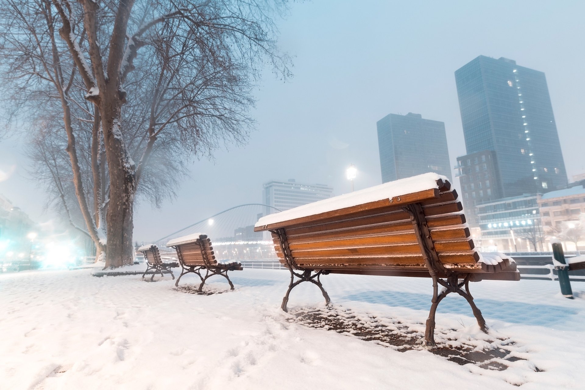 Winter Serenity: Snow-Covered Benches in HD Urban Landscape
