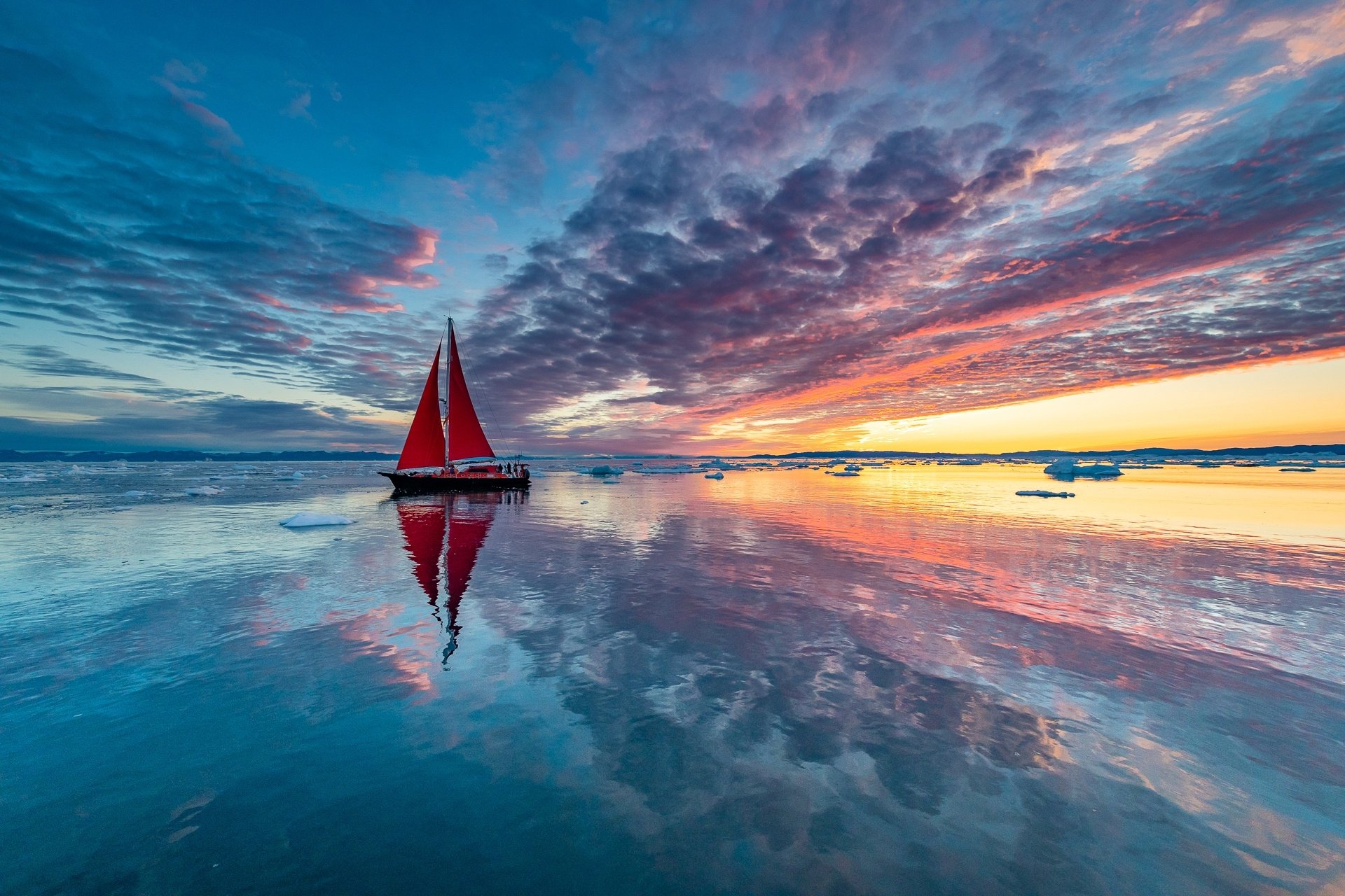 Sailing Serenity: Ocean Reflections Beneath a Dramatic Sky – HD Wallpaper