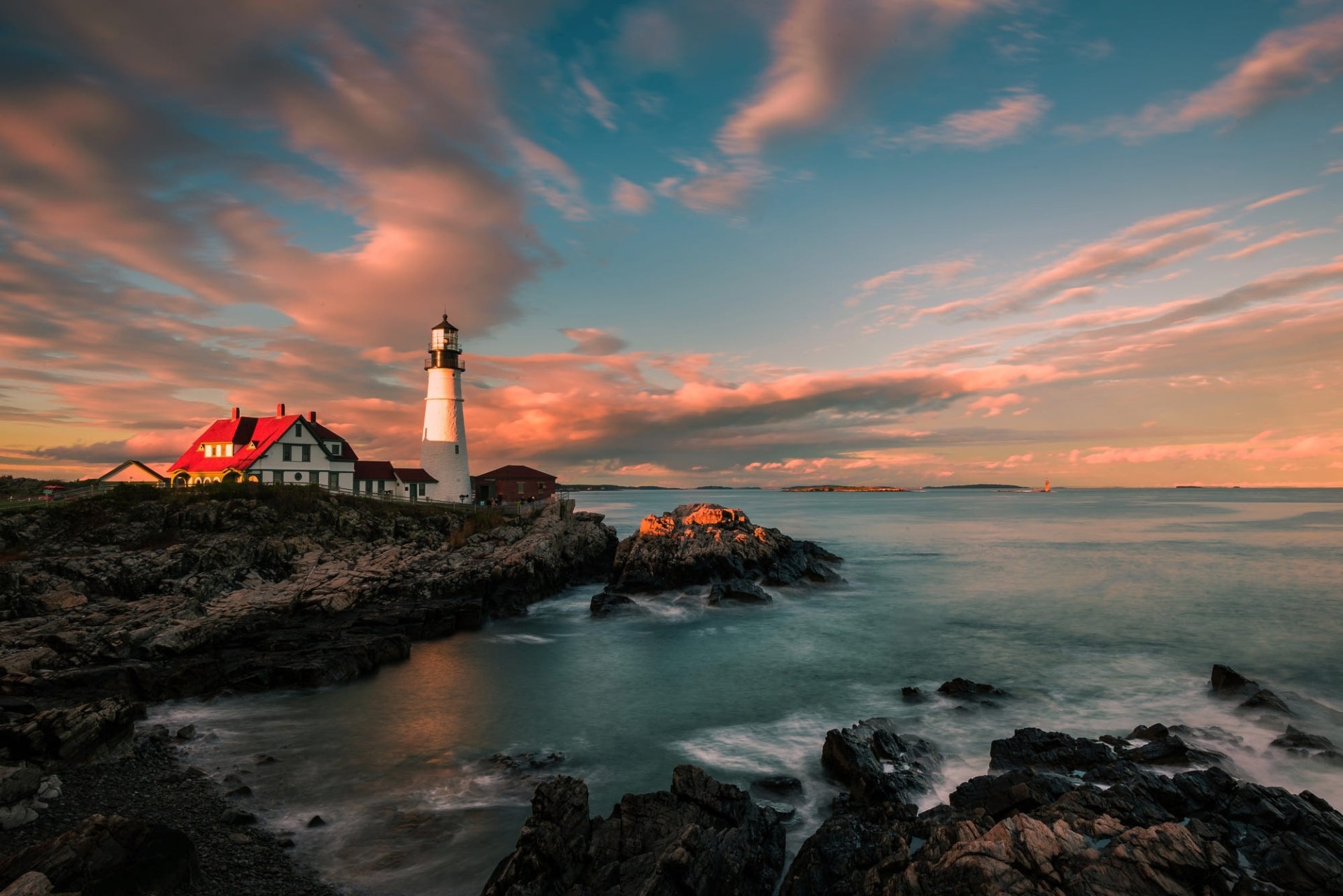 Majestic Lighthouse at Sunset Over Ocean and Rocks - HD Wallpaper
