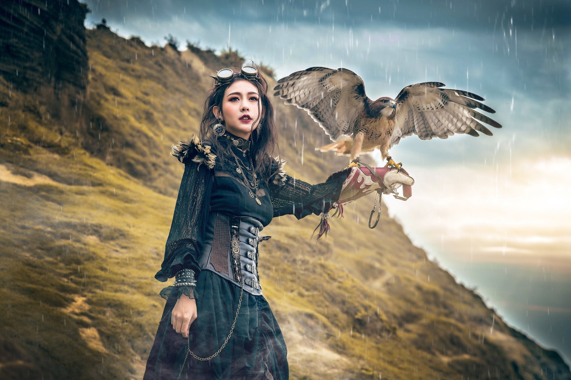 Stormbound Grace: Asian Falconer with Goggles in Wild Highlands HD ...
