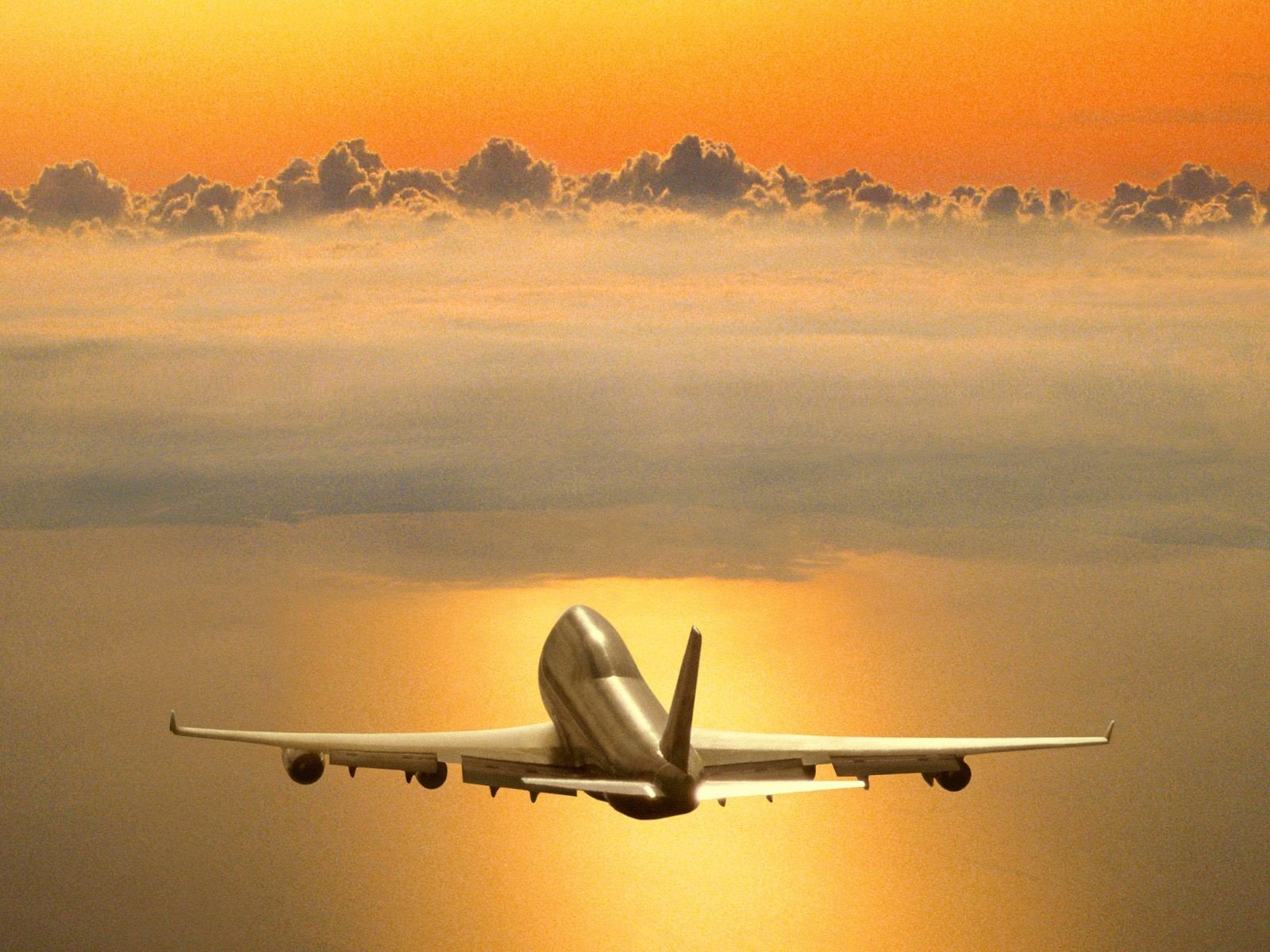 Silver Jet Soaring Through Golden Clouds – HD Airplane Wallpaper