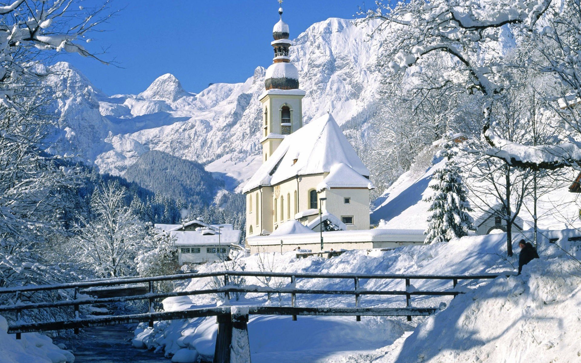 Winter Serenity: Snow-Covered German Church Amidst Alpine Trees
