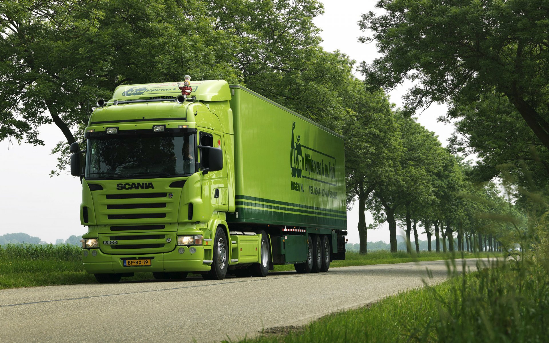 Scania Power: HD Wallpaper of a Vibrant Green Truck on the Open Road
