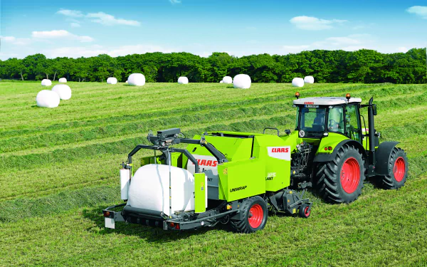 Claas Axion 990 Tractor: HD Wallpaper in a Dramatic Field Landscape