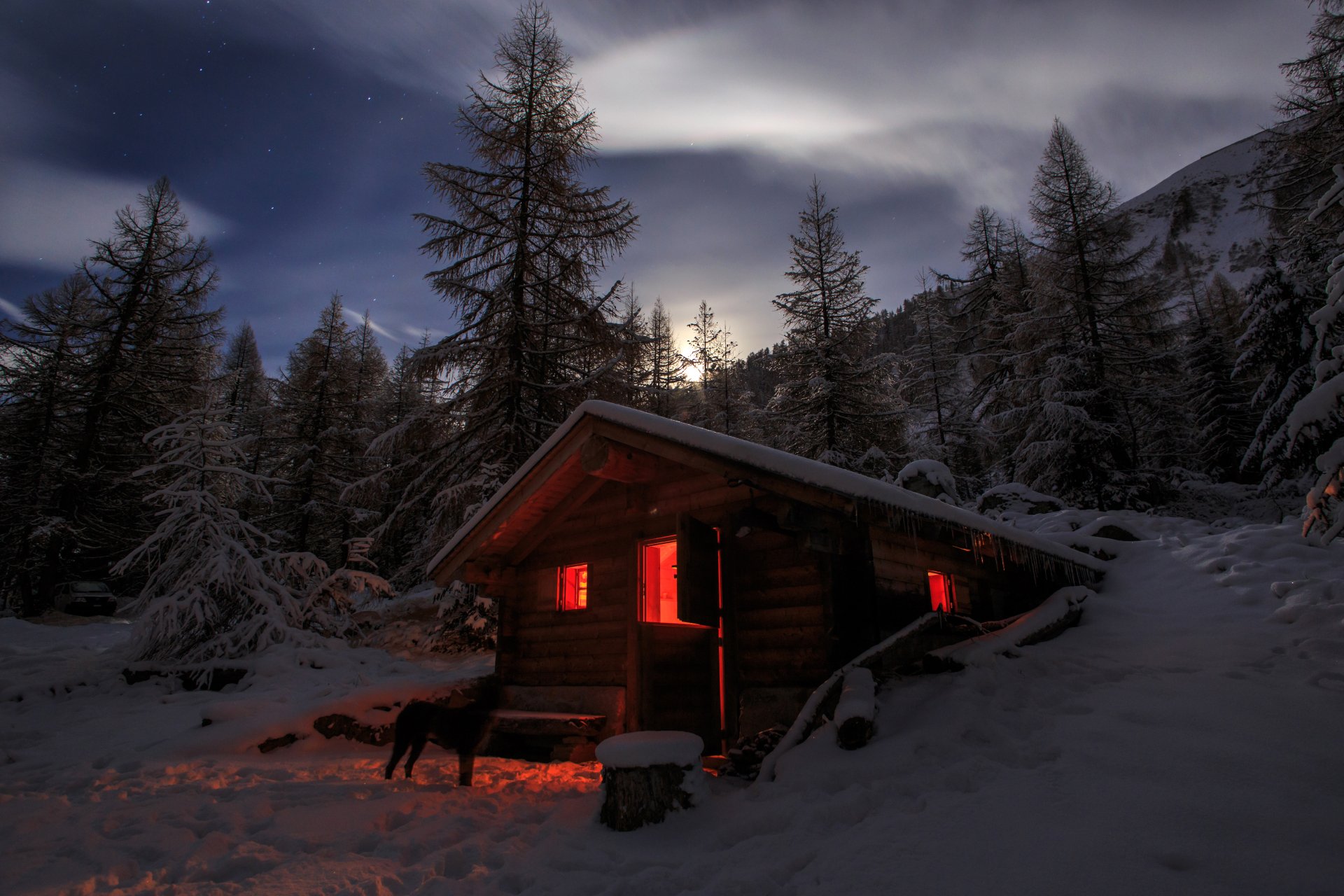 Winter Night Glow: Cozy Cottage Amid Snowy Earth in 4K Ultra HD