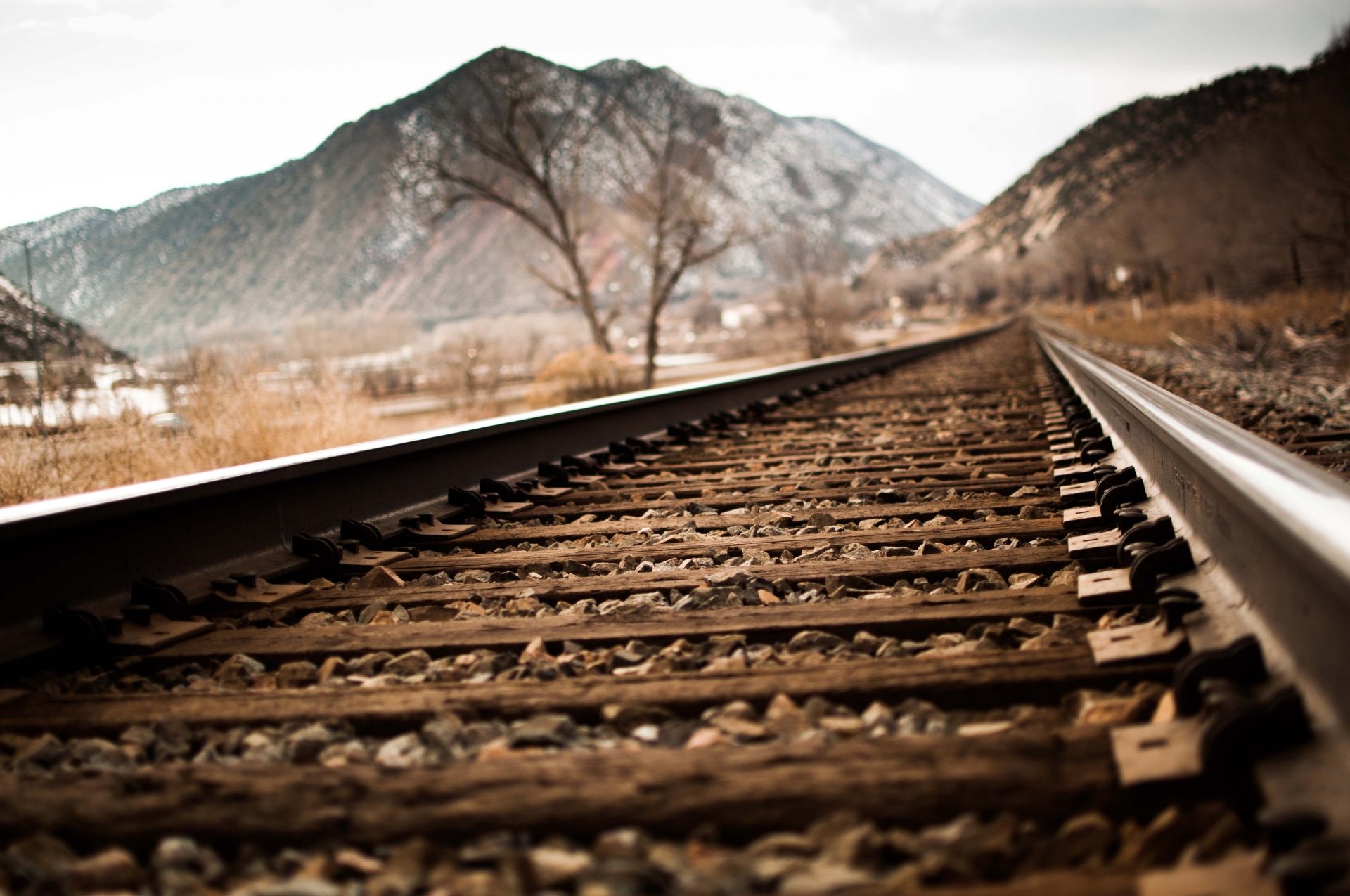 4K Railroad Close-Up: Tracks Leading to Snowy Mountains