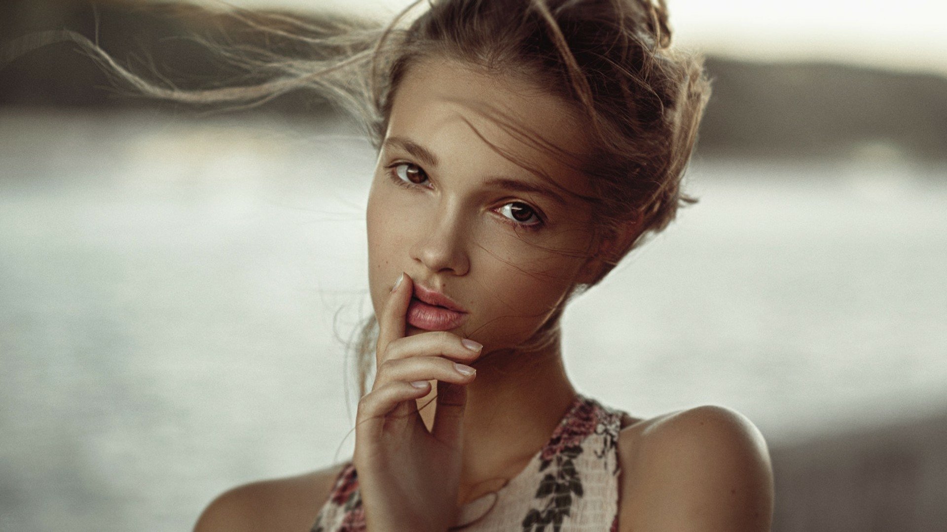 Wind-Kissed Beauty: Close-Up of a Brown-Eyed Model's Serene Face by ...